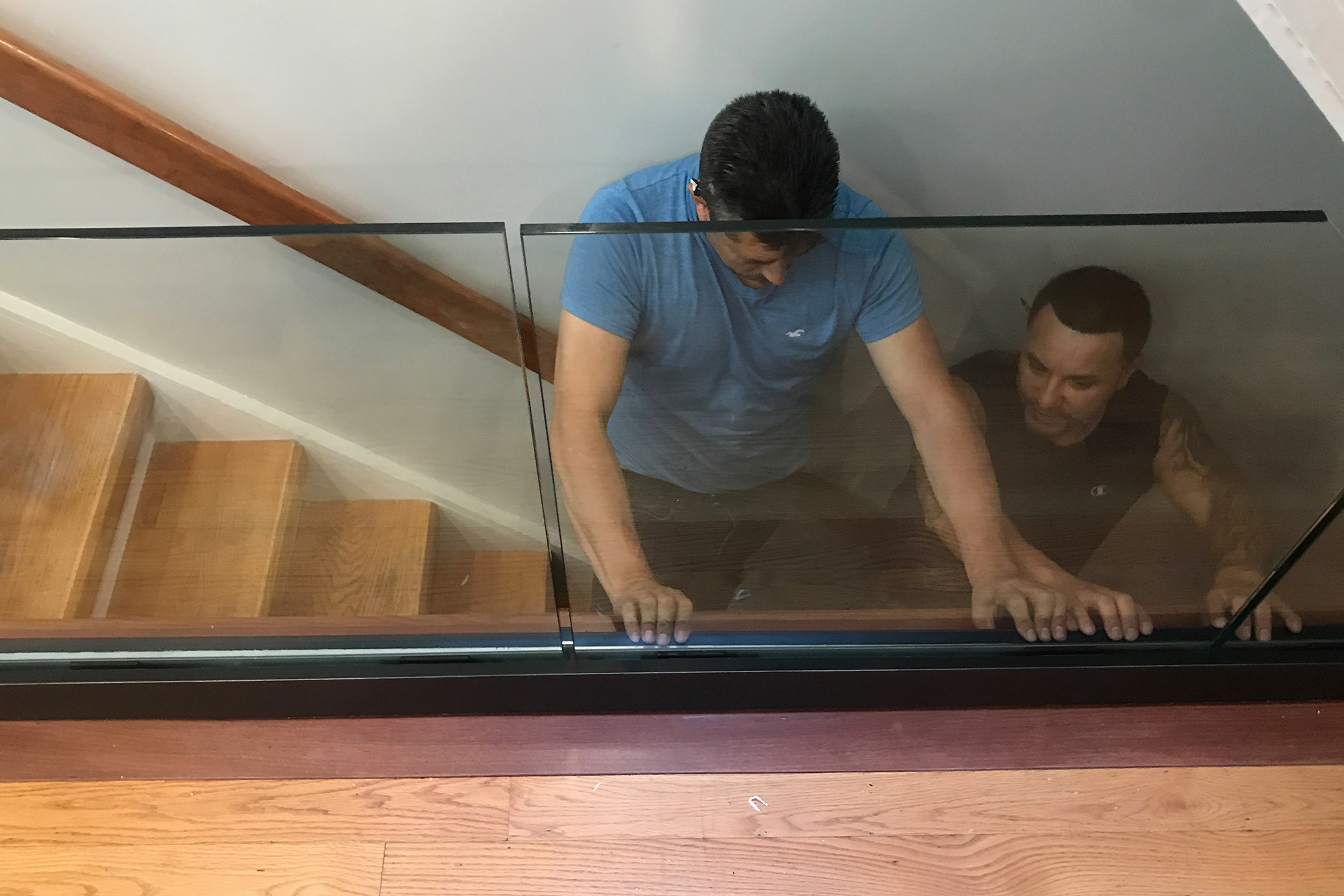 A Frameless Glass Guard Opens Up a Narrow Room